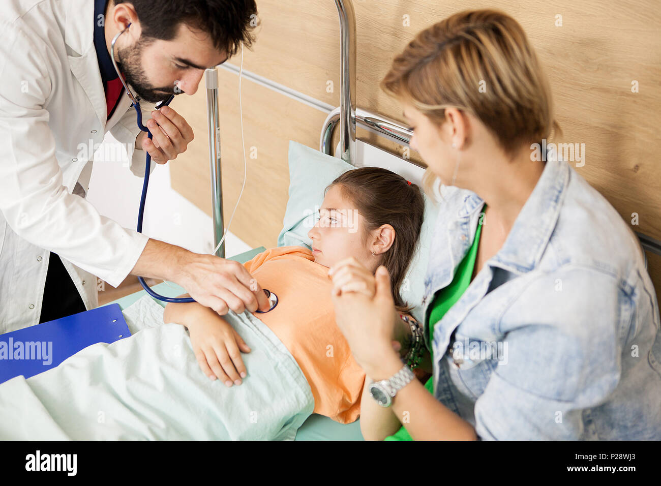 Doctor checking her patient heart Stock Photo - Alamy