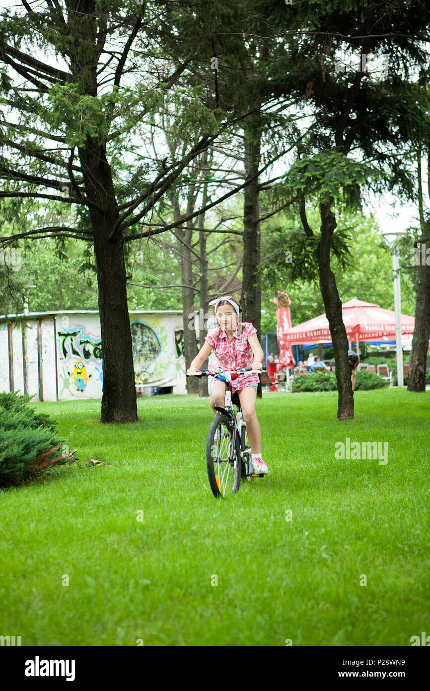 Girl feeling good while riding her bicycle Stock Photo - Alamy