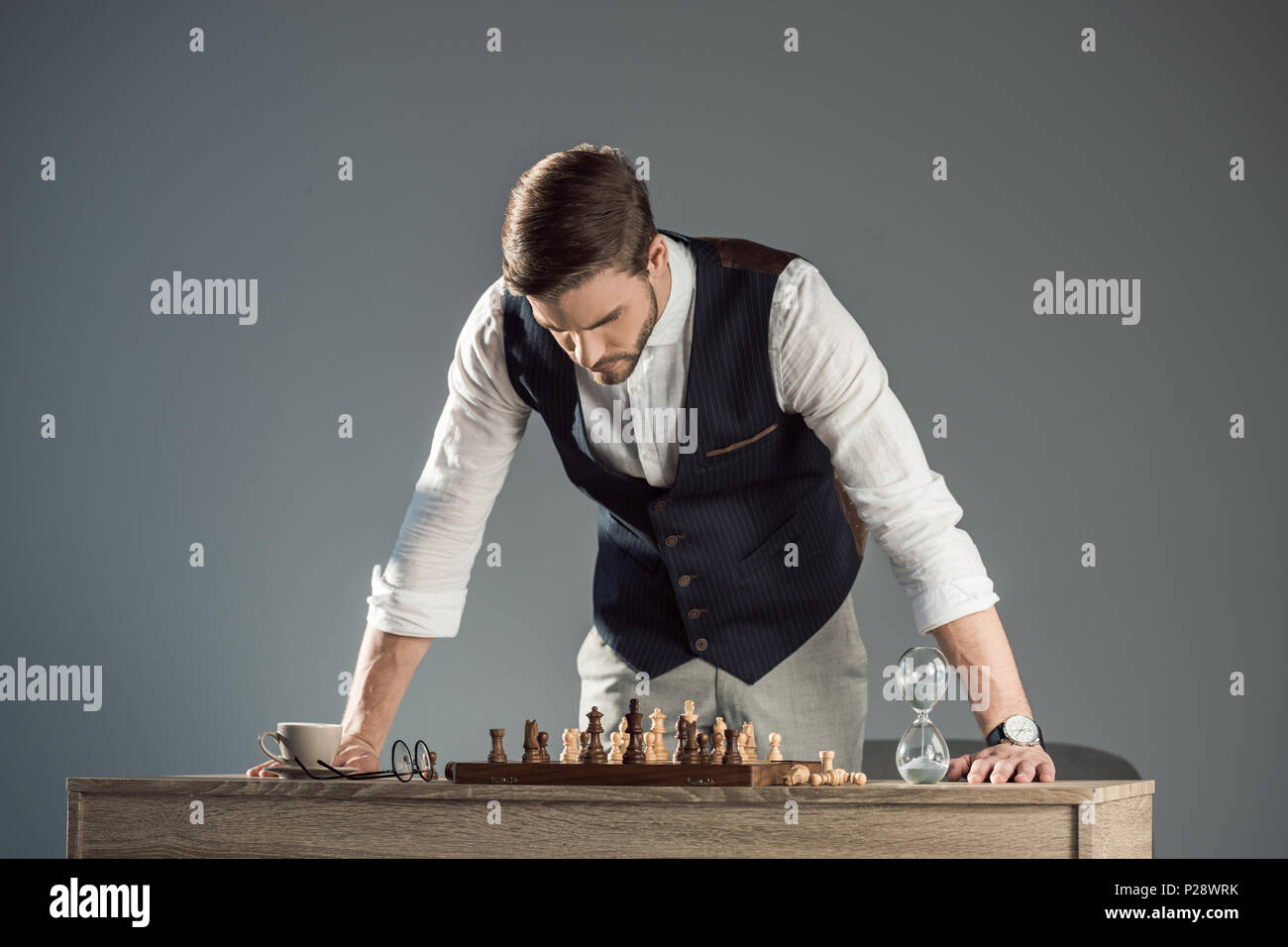 focused bearded stylish man looking at chess board with figures Stock ...