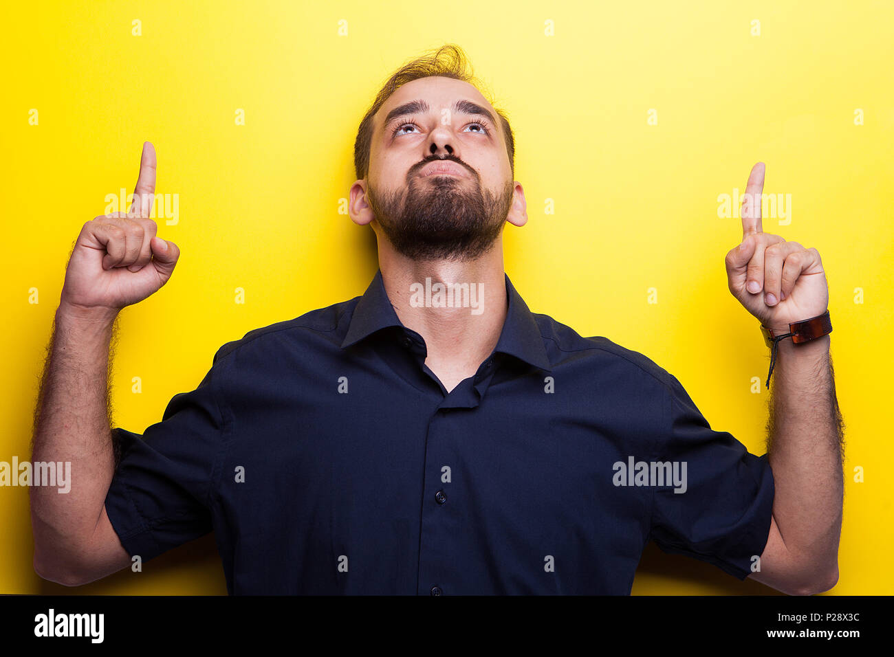 young attractive smart man showing hand signs pointing up Stock Photo ...