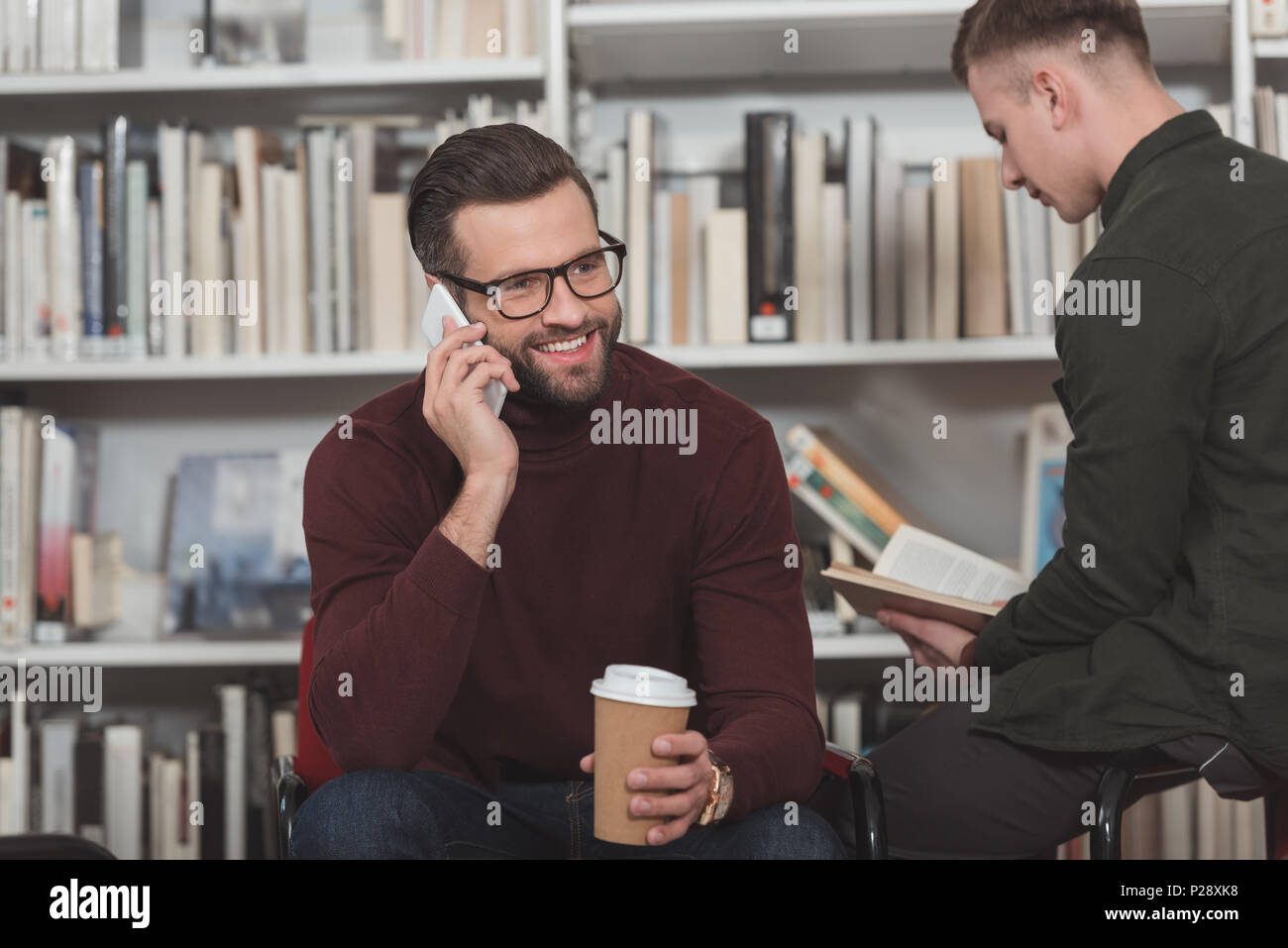Friends, library, talking, male hi-res stock photography and images - Alamy