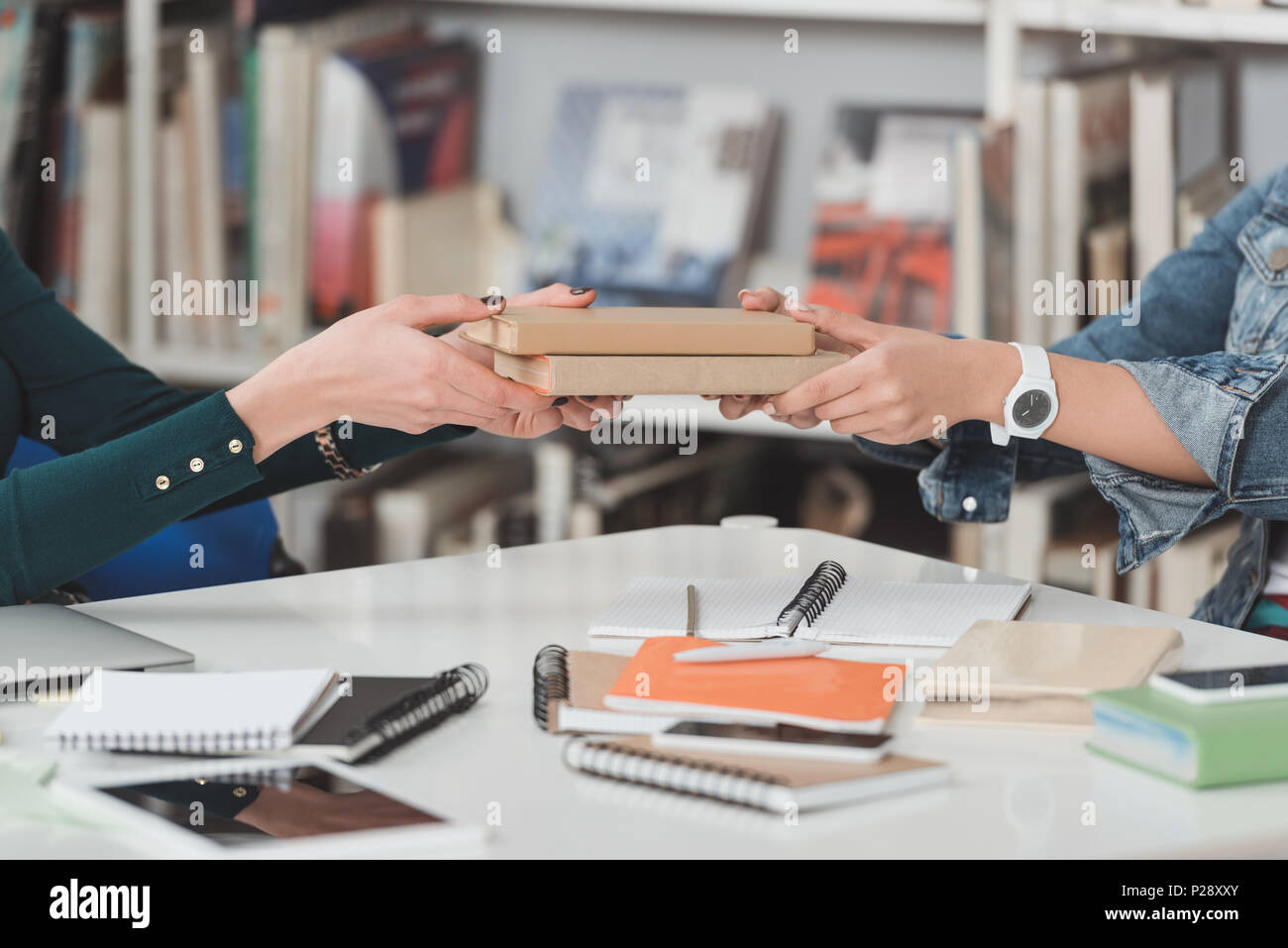 Giving books to girl hi-res stock photography and images - Alamy