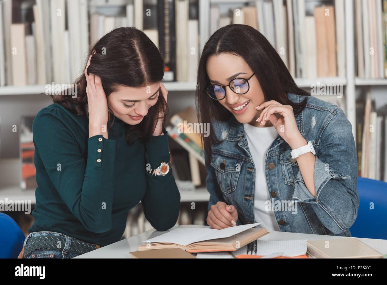 Young adults reading in library hi-res stock photography and images - Alamy