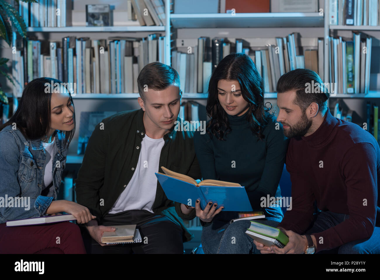 multicultural students reading book and preparing to exam Stock Photo ...