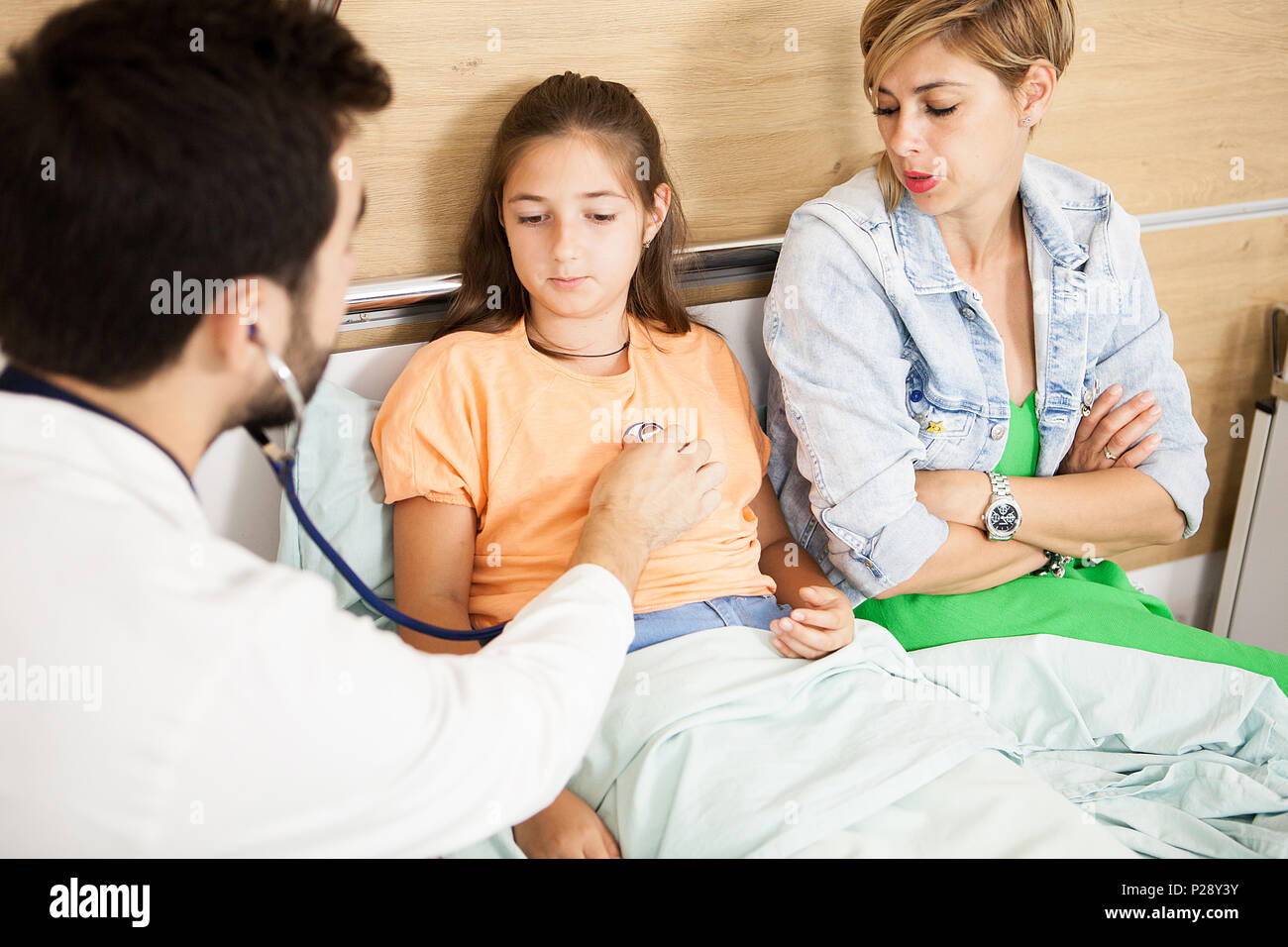 Doctor checking her patient heart Stock Photo - Alamy
