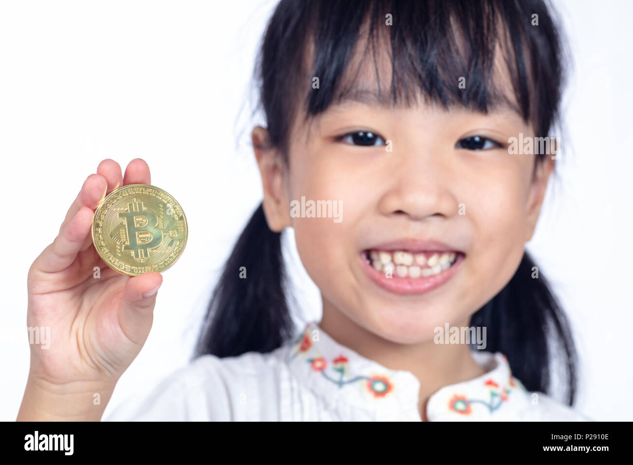 Asian Chinese little girl holding golden Bitcoin in isolated white ...