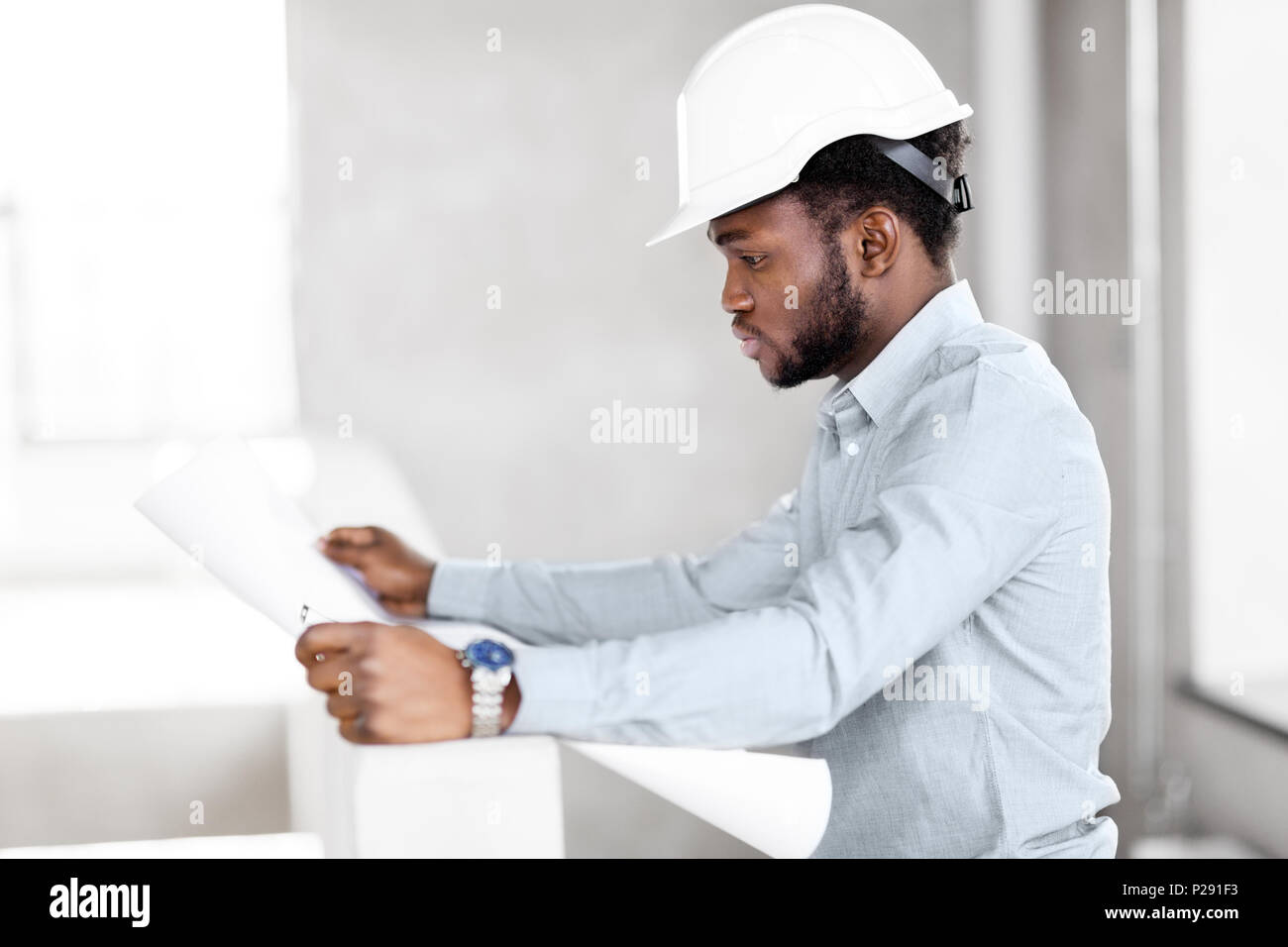 african architect in helmet with blueprint Stock Photo - Alamy