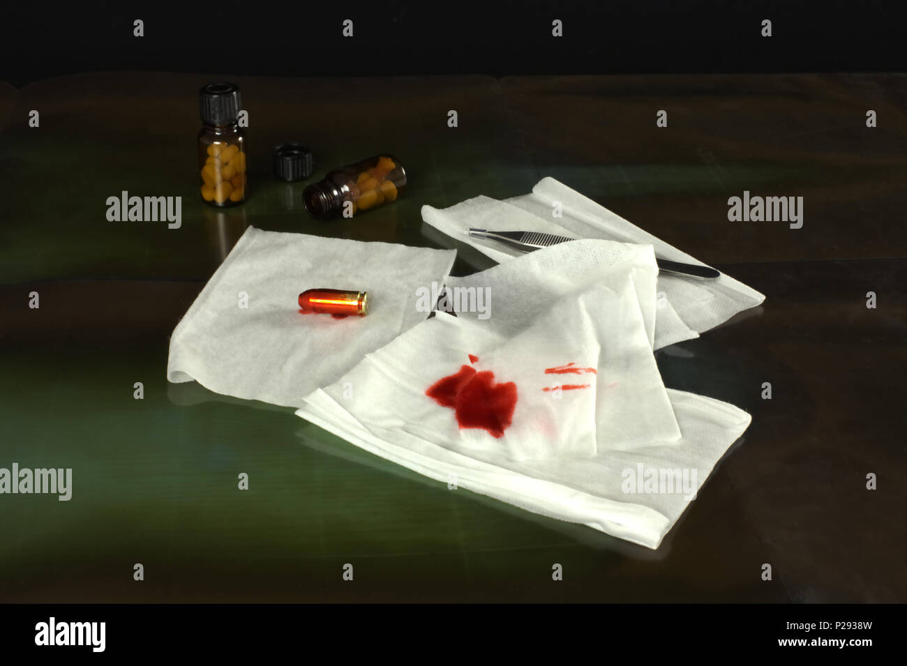 A bullet removed from a human body, blood, some pill bottles Stock ...