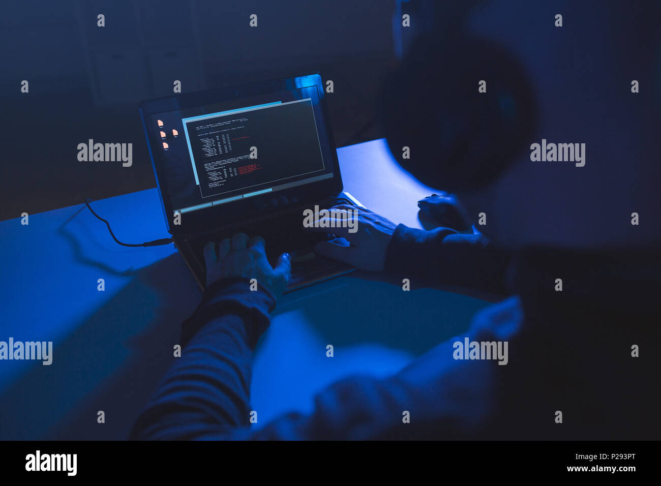 hacker with coding on laptop computer in dark room Stock Photo - Alamy