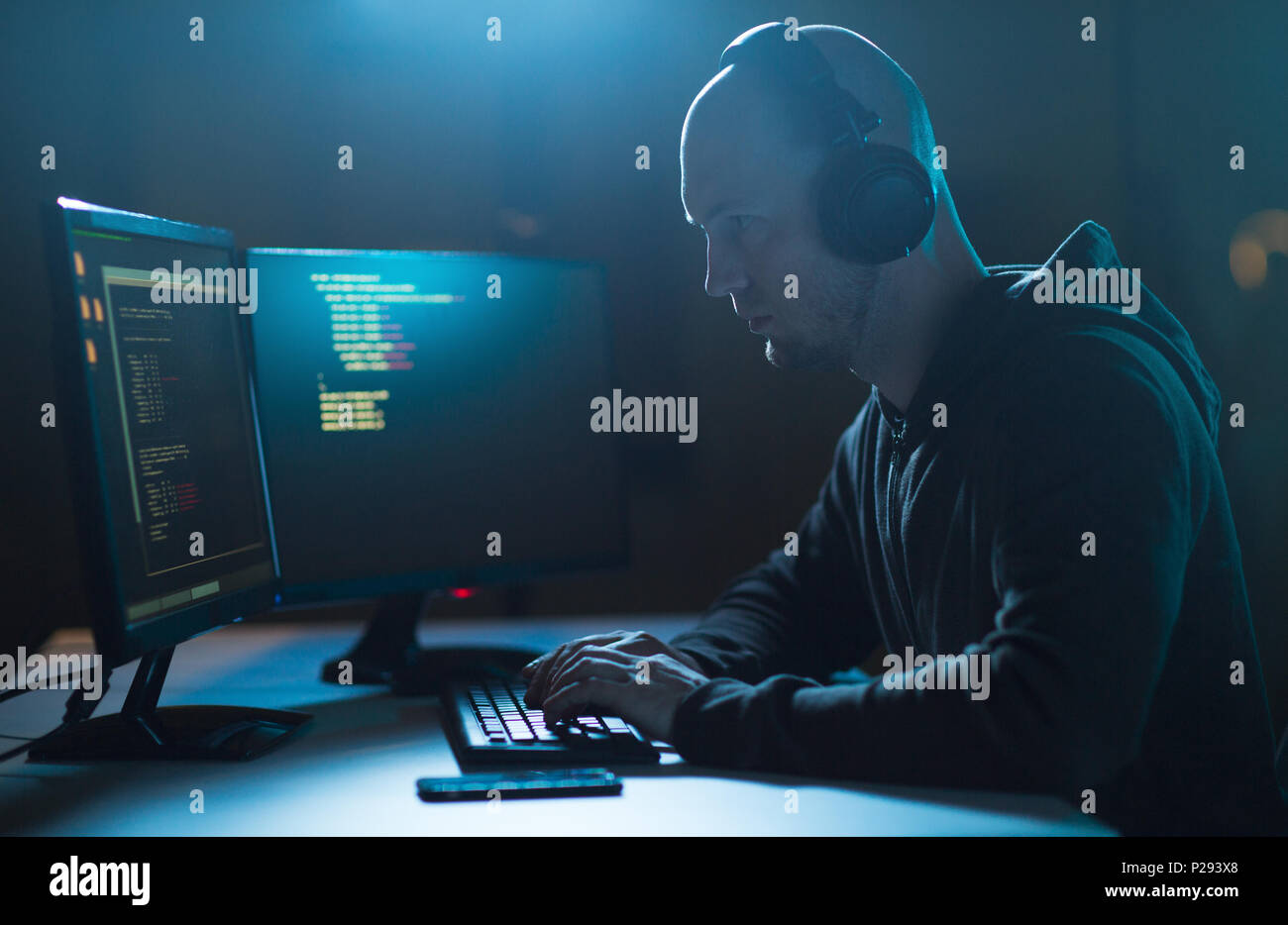 hacker with coding on laptop computer in dark room Stock Photo - Alamy