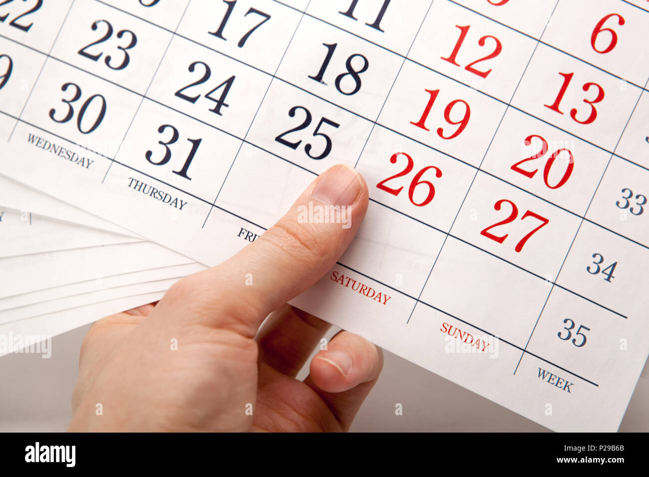 pile of calendar sheets in hand closeup Stock Photo - Alamy
