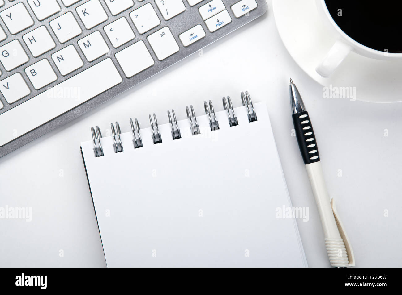 notebook, coffee cup and keyboard on the desktop Stock Photo - Alamy