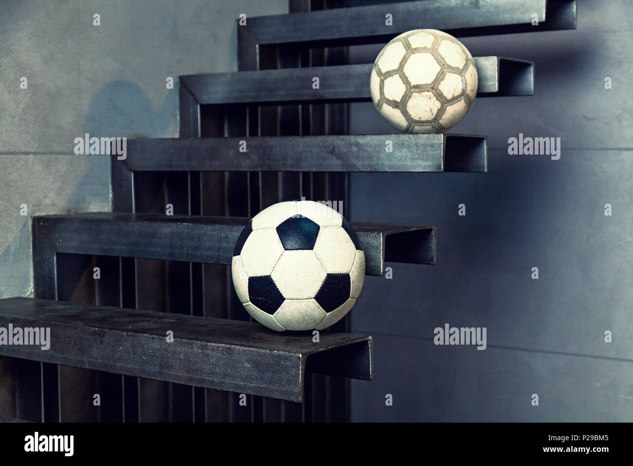soccer ball lies on a metal staircase.soccer ball with metallic ...