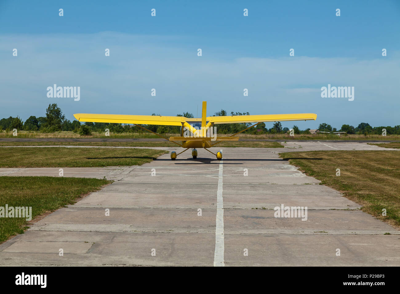 Light yellow aircraft on a private airfield to prepare for the flight ...