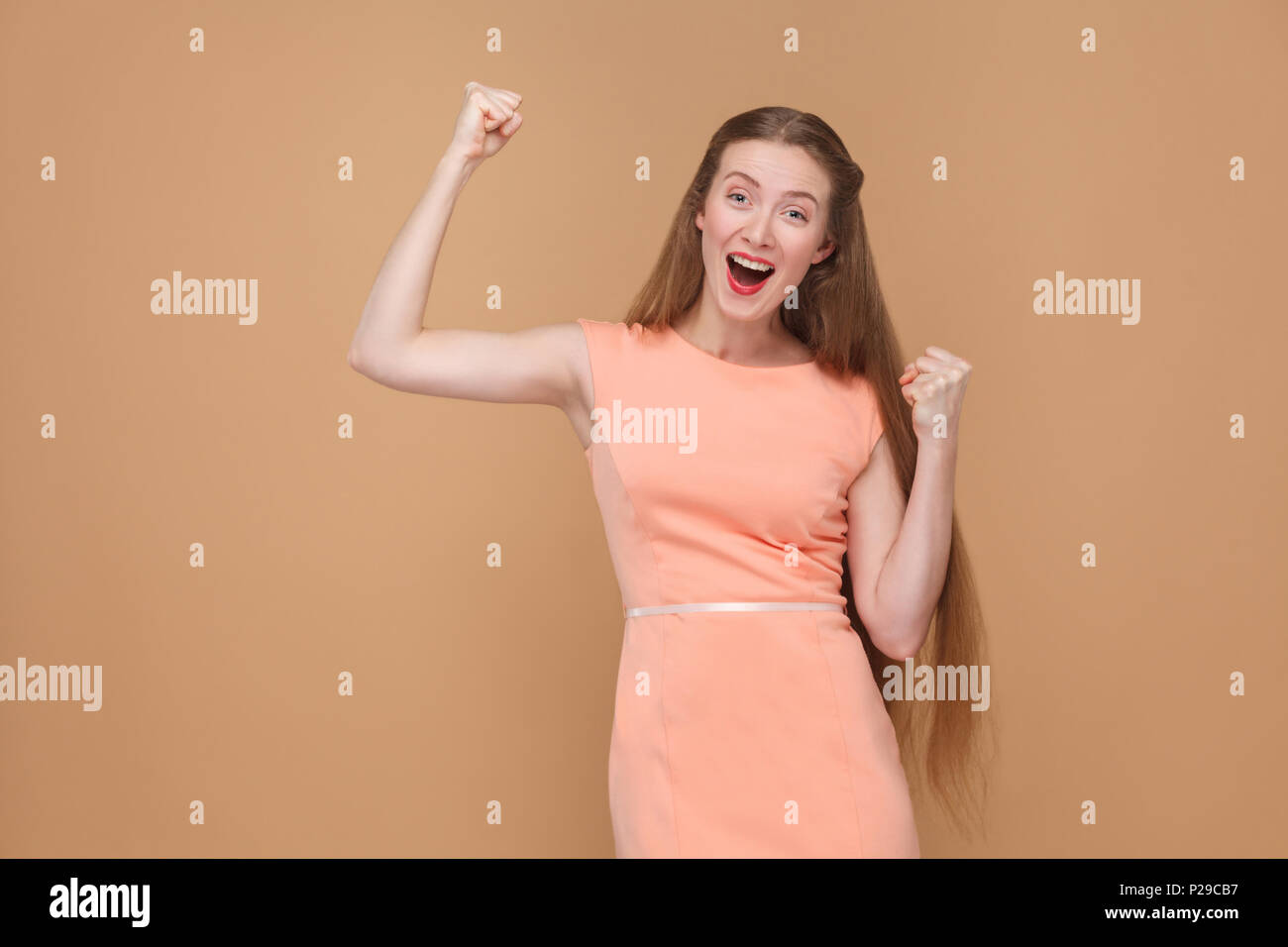 amazed winner girl showing victory sign. portrait of emotional cute ...