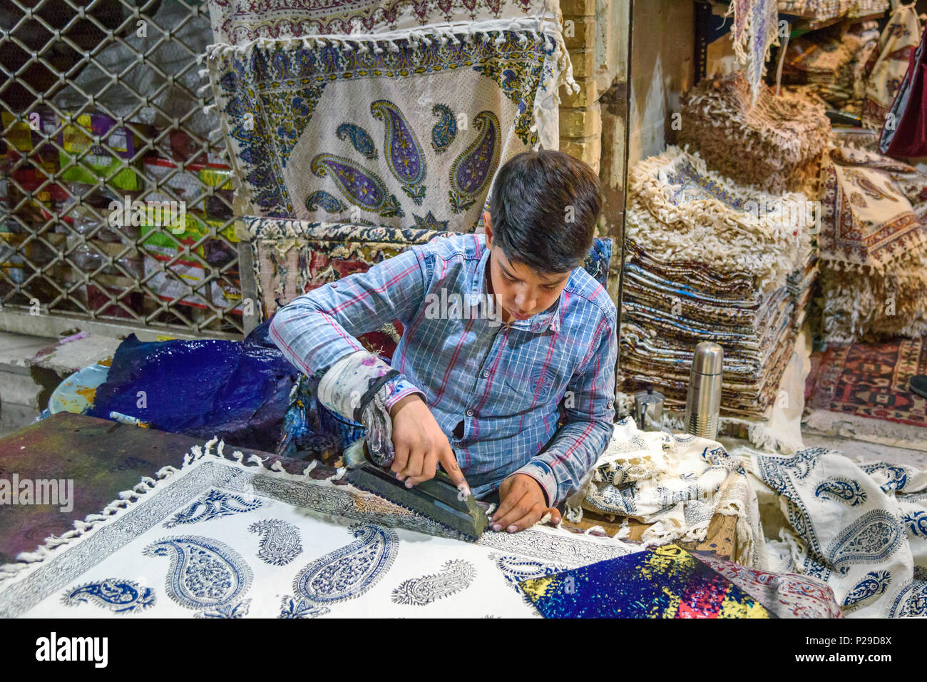 Isfahan, Iran - March 21, 2018: Iranian young boy using carved wooden ...