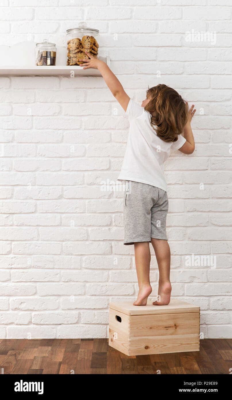 Child sneaking food hi-res stock photography and images - Alamy