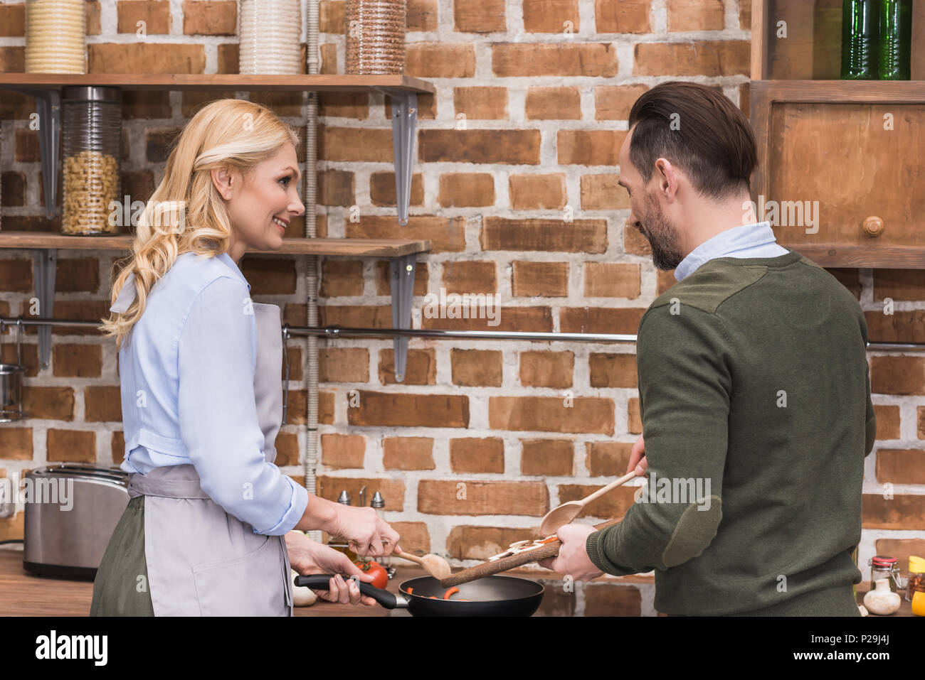 wife and husband cooking together at kitchen Stock Photo - Alamy