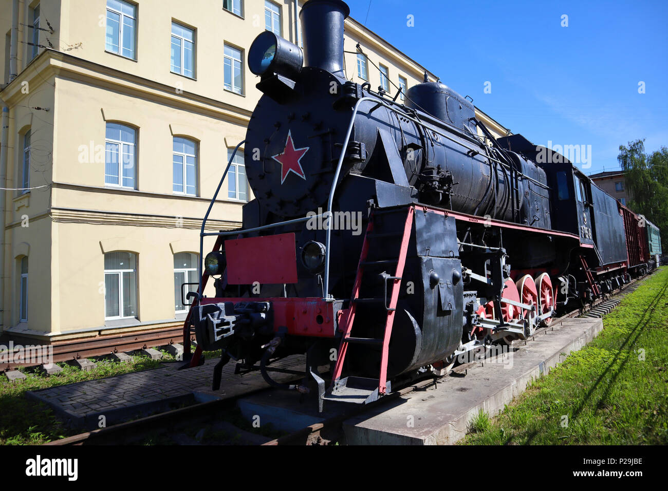 Old russian soviet steam locomotive with wagons standing outdoors on ...
