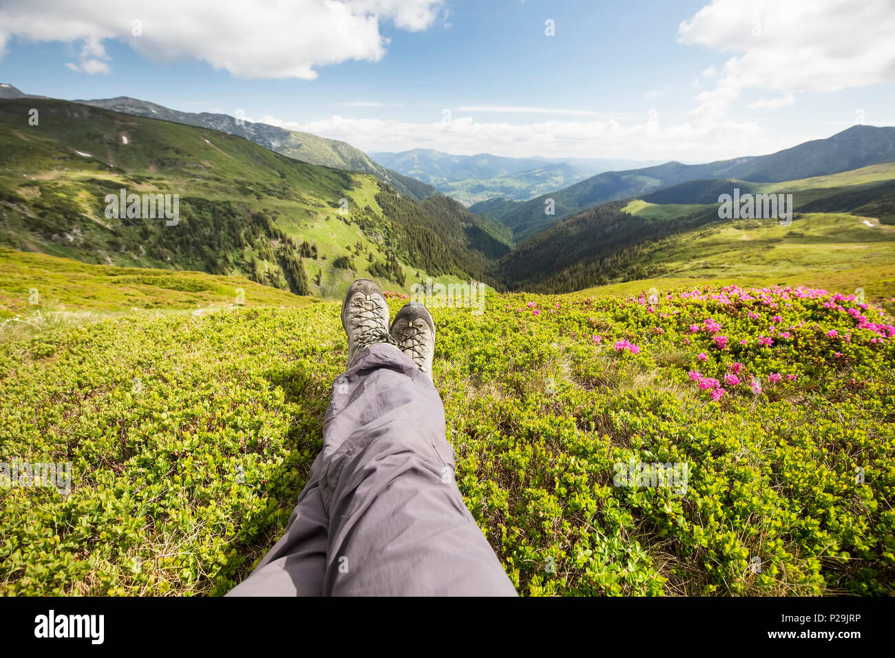 Mountain hiking. Hiker feet resting on top of the hill. Beautiful ...