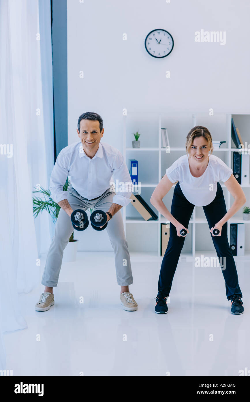 handsome businessman with his female personal trainer working out with ...