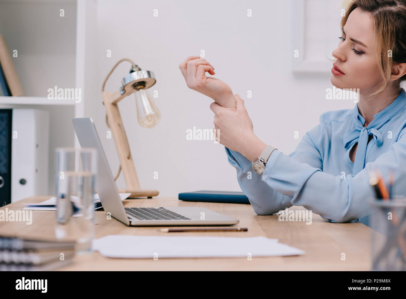 overworked businesswoman with arrhythmia measuring her heart rate at ...