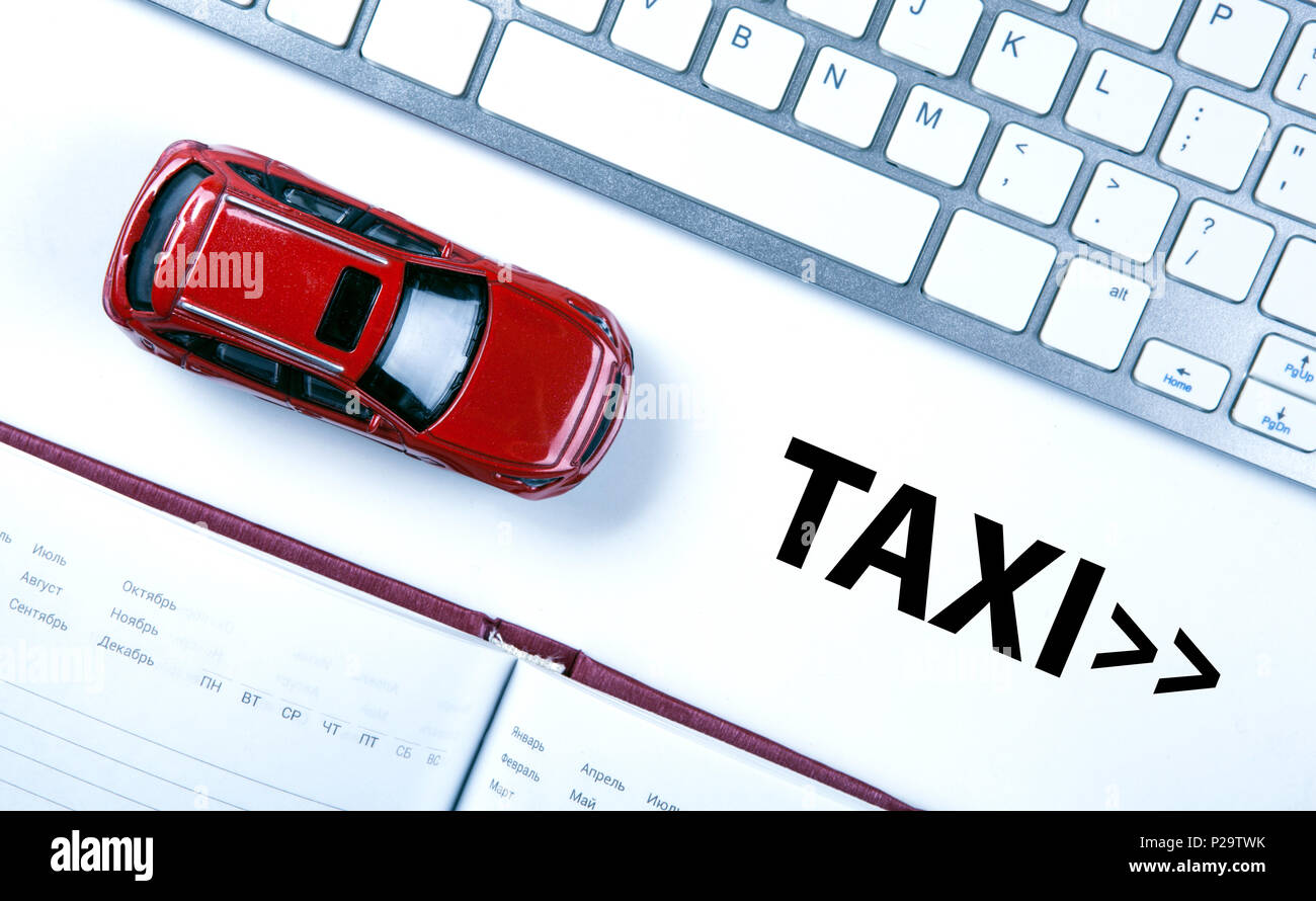 red car model near the keyboard on the desktop and the inscription of a ...