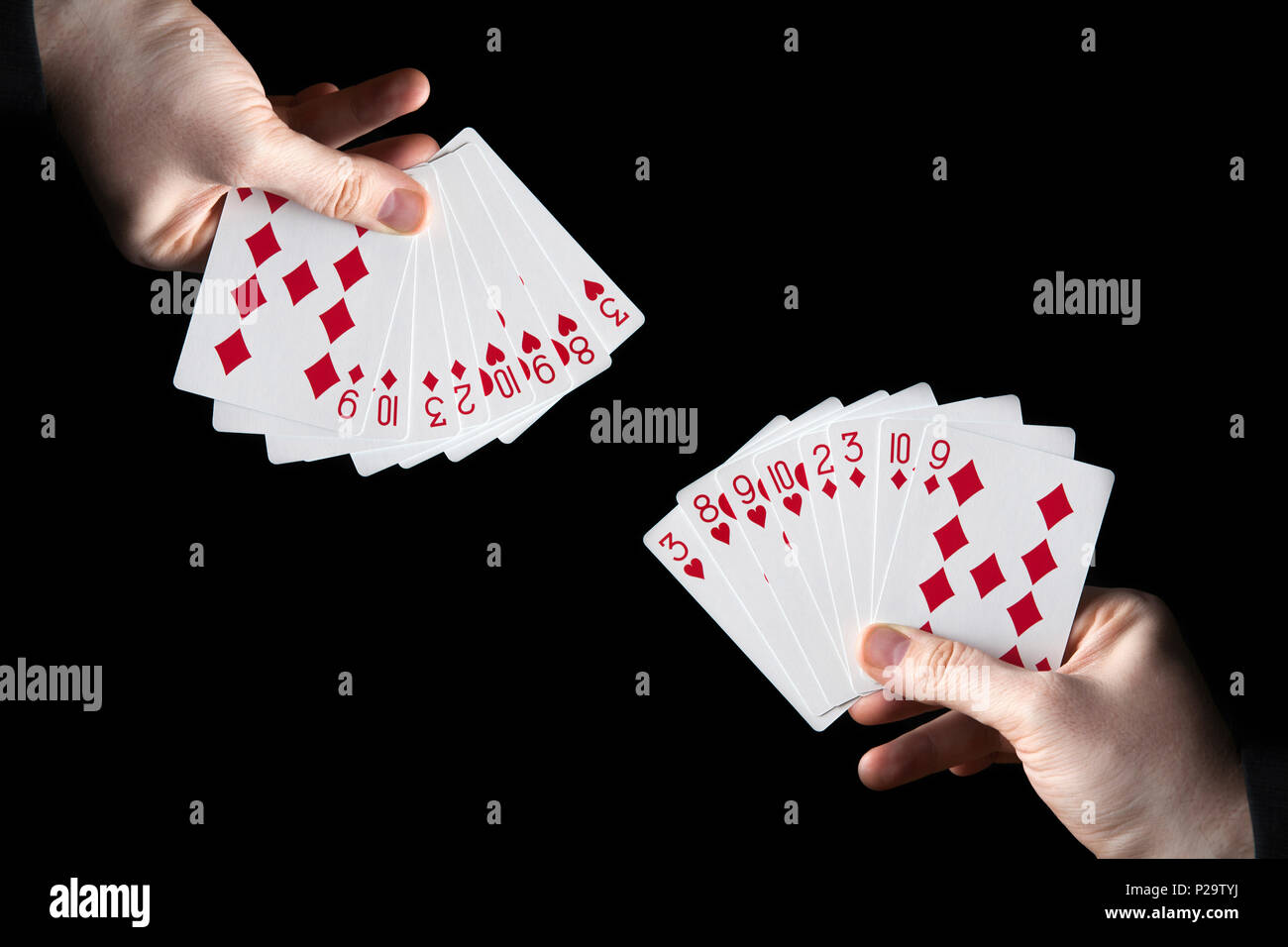 male hands hold a fan of playing cards on a black background Stock ...