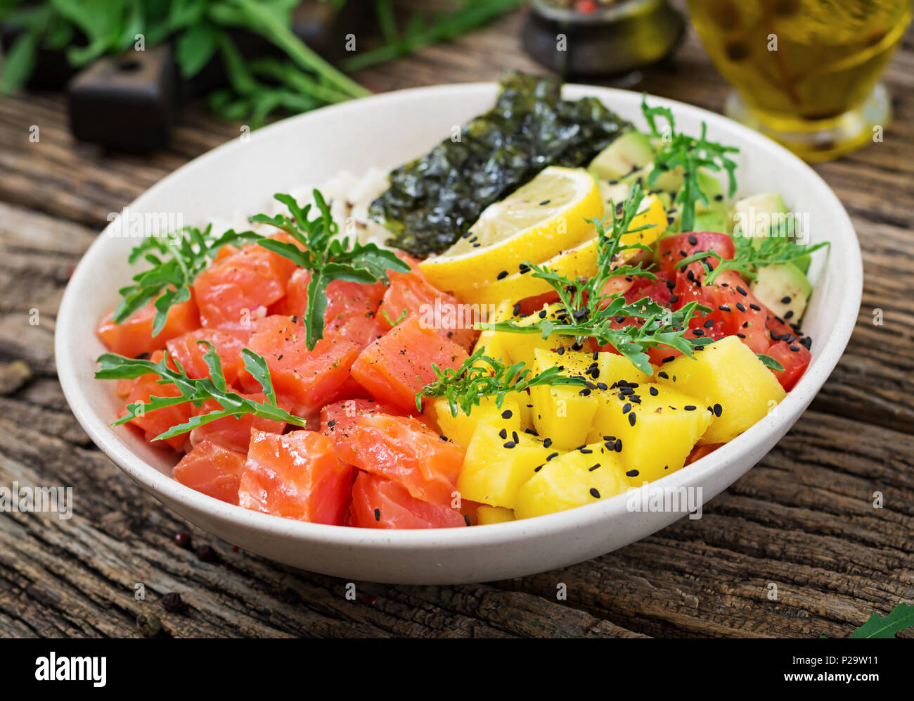 Hawaiian salmon fish poke bowl with rice, avocado, mango, tomato ...