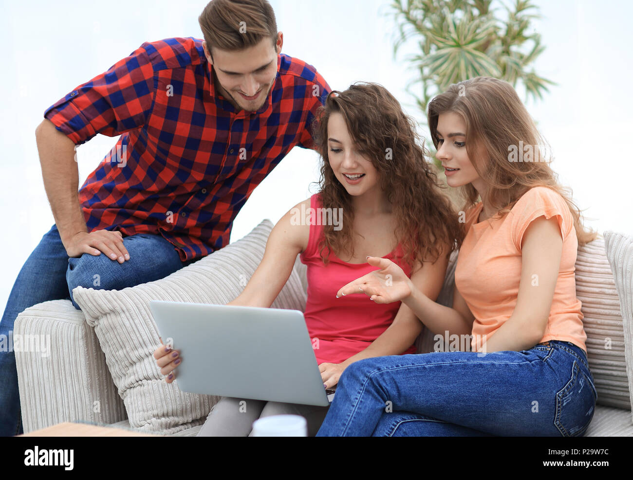 group of students sitting on the sofa in the living room Stock Photo ...