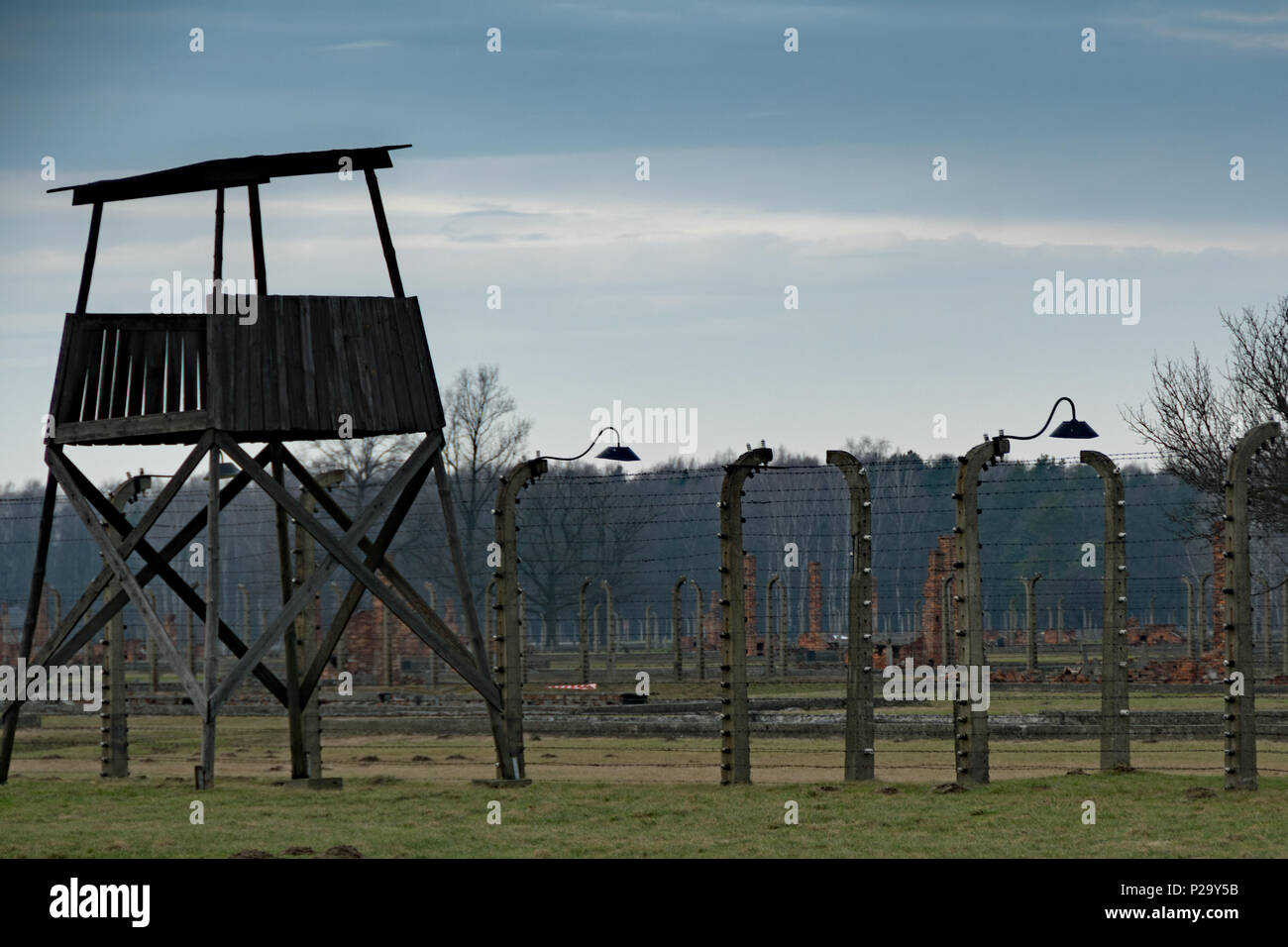 Guard tower sitting along a once electrified fence at Auschwitz ...