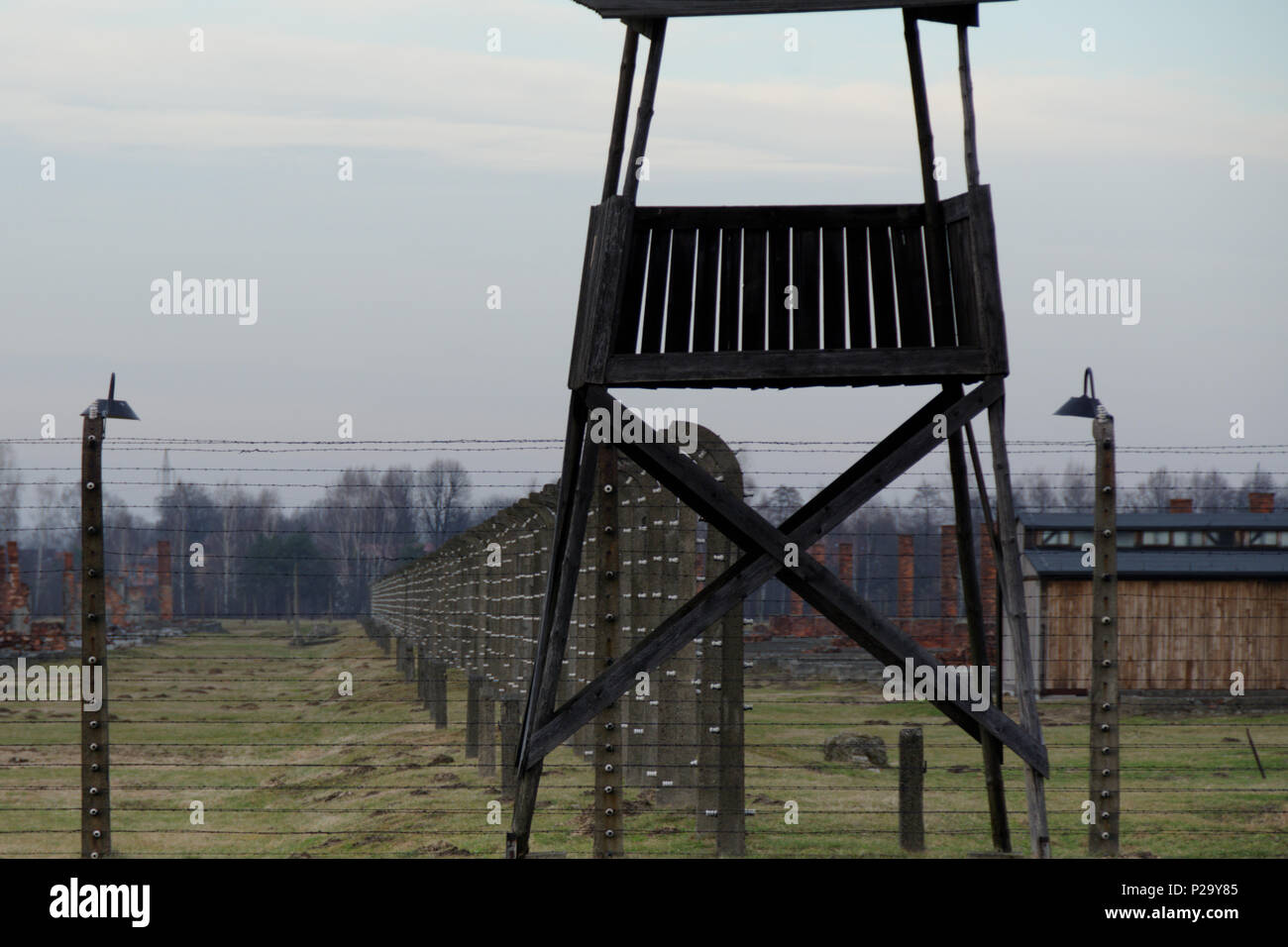 Guard tower sitting along a once electrified fence at Auschwitz ...
