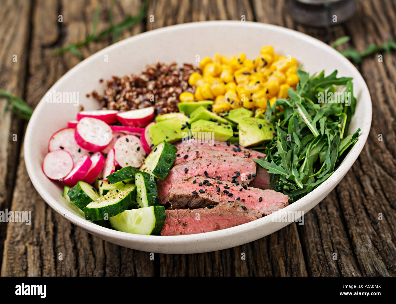 Healthy dinner. Buddha bowl lunch with grilled beef steak and quinoa ...