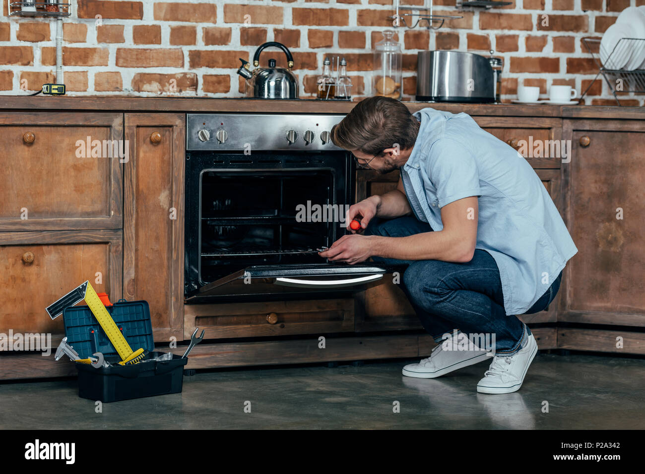 Man repairing oven hi-res stock photography and images - Alamy