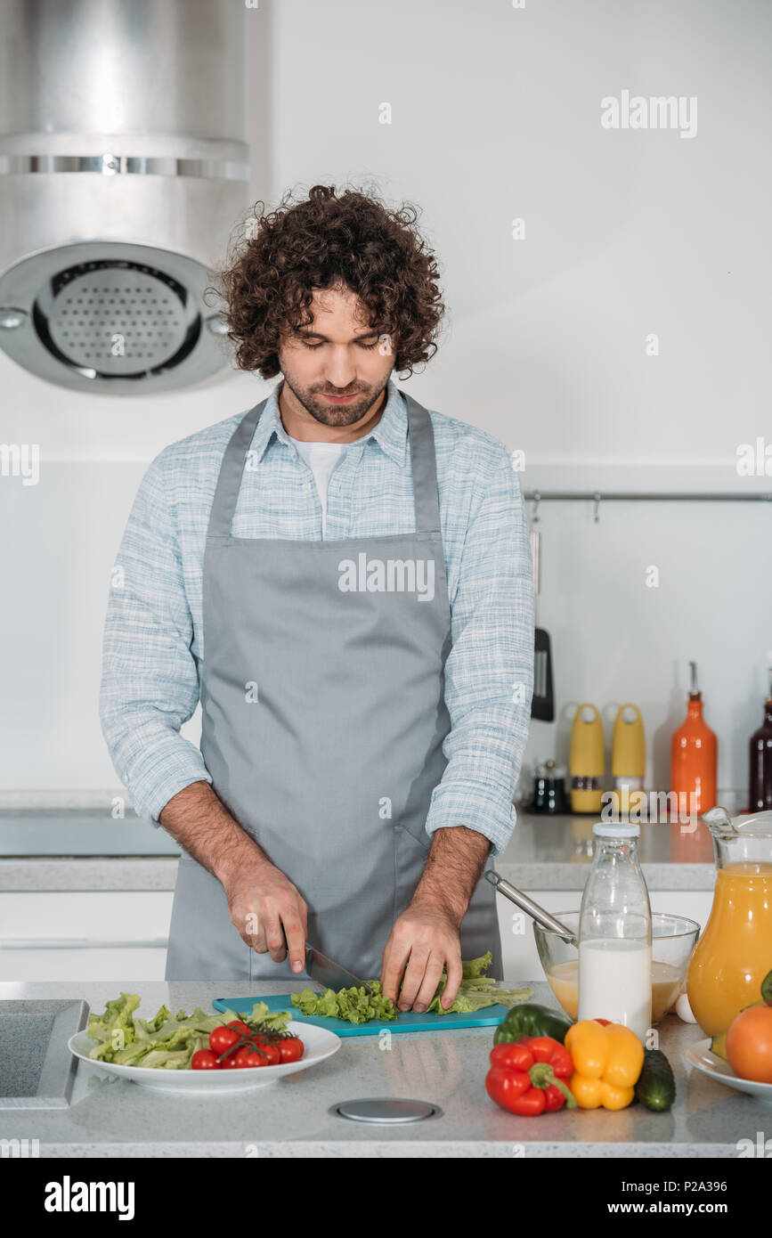 handsome man cutting vegetables for salad Stock Photo - Alamy