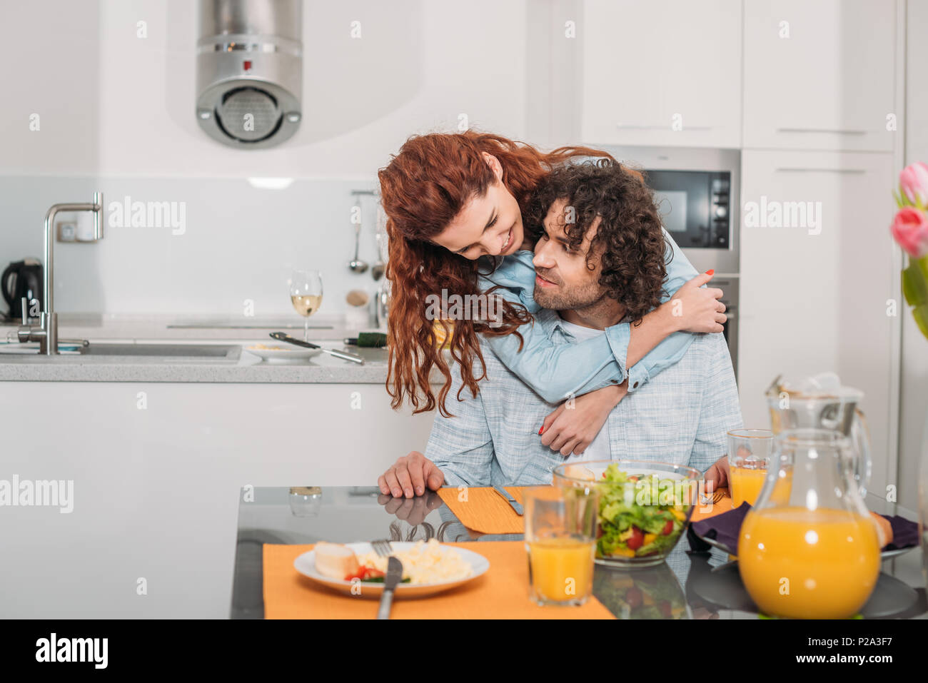 happy girlfriend hugging boyfriend from back at kitchen Stock Photo - Alamy