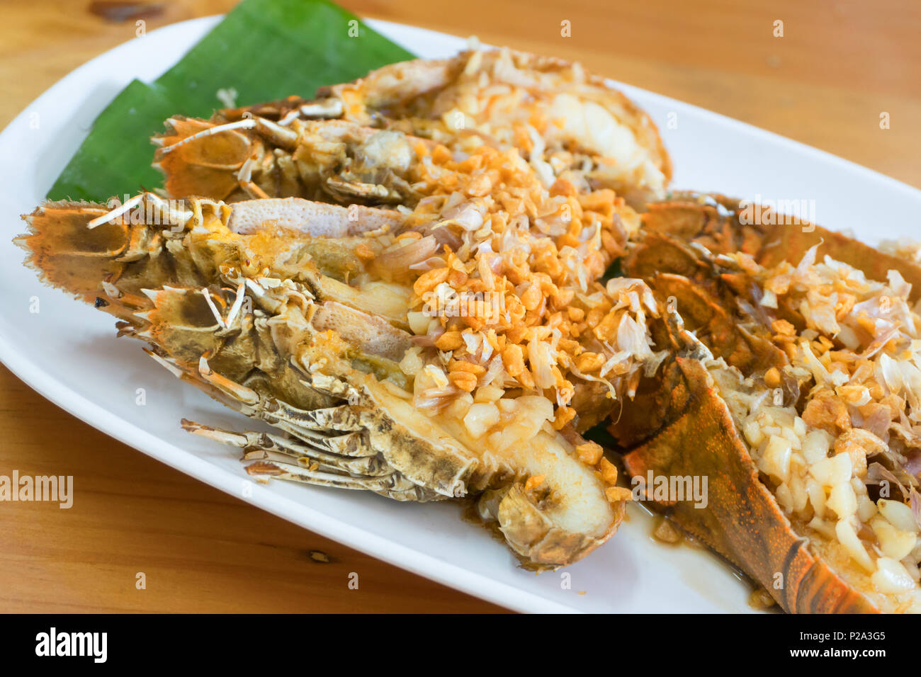 crayfish fried fill pickled garlic served on wood table Stock Photo - Alamy