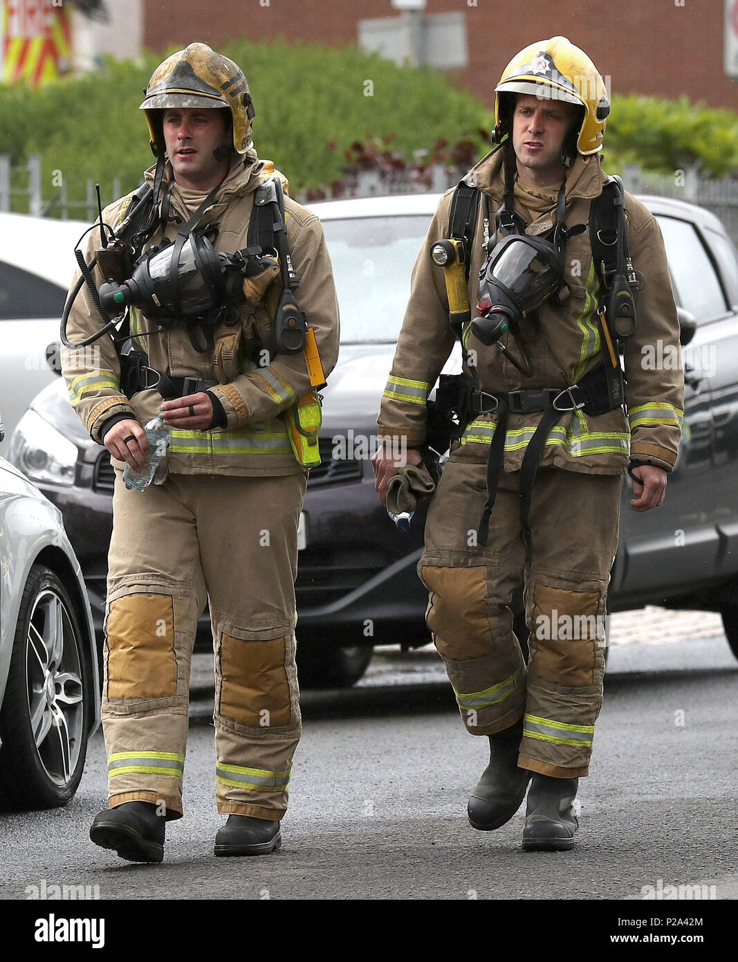 Firemen on the scene at Commercial Court in Glasgow after a fire on the ...