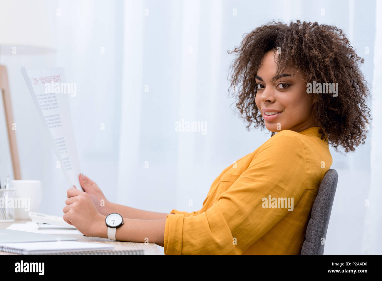 side view of beautiful young woman doing paperwork Stock Photo - Alamy