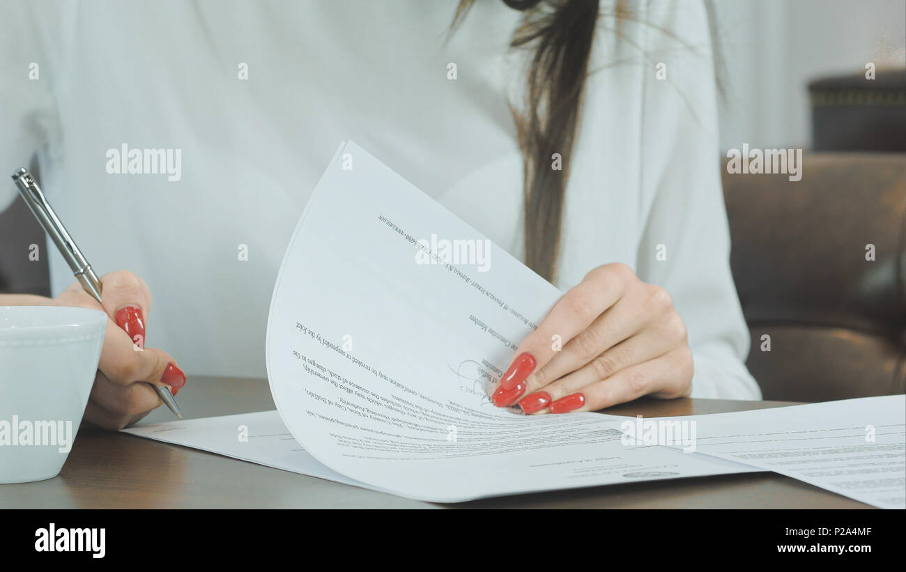 Woman hand with red nails signing formal papers Stock Photo - Alamy