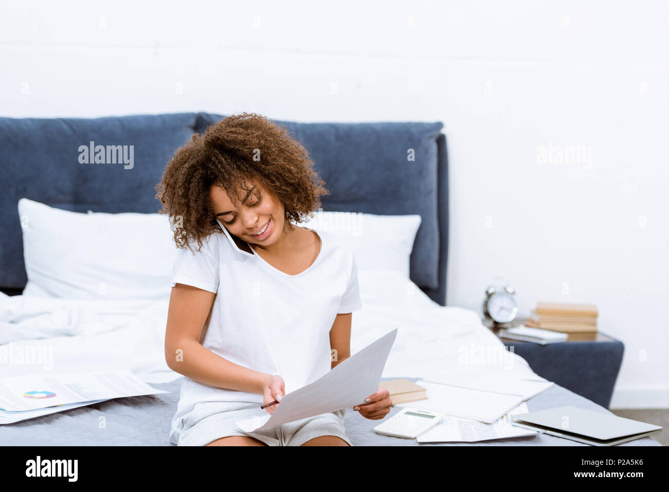 Woman doing remote multitasking hi-res stock photography and images - Alamy