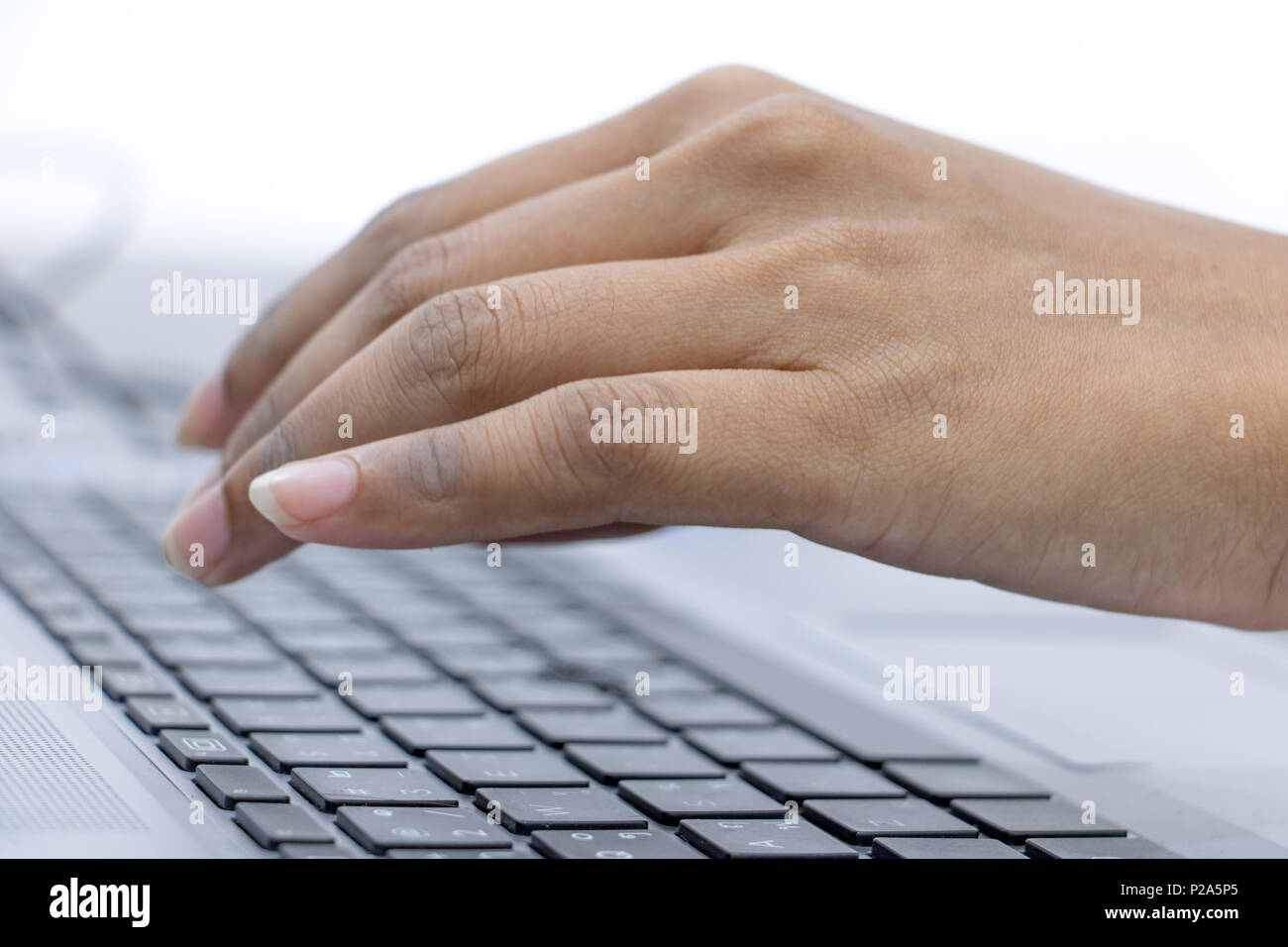 Close-up view of female hand write on keyboard of notebook Stock Photo ...