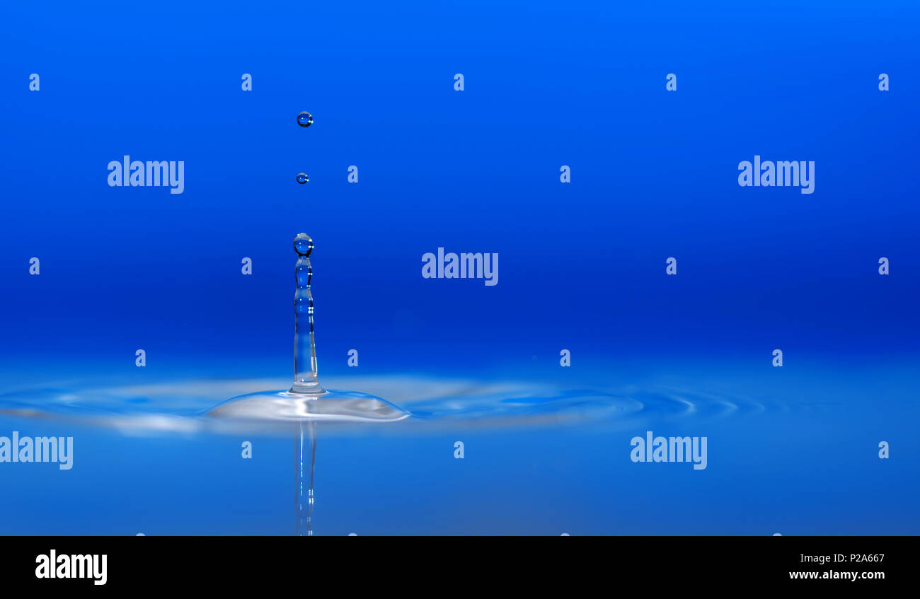 Water drop falling into water making a perfect droplet splash Stock Photo - Alamy