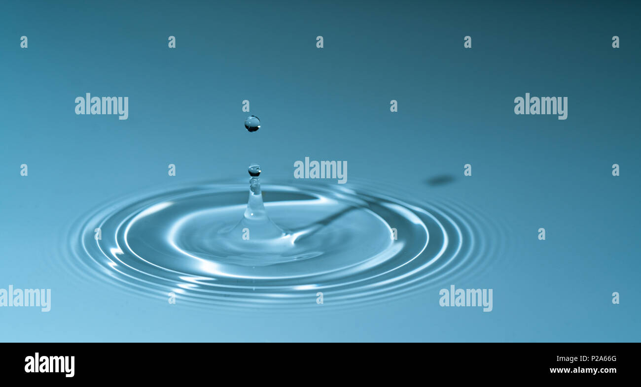 Falling water drop splash Stock Photo - Alamy