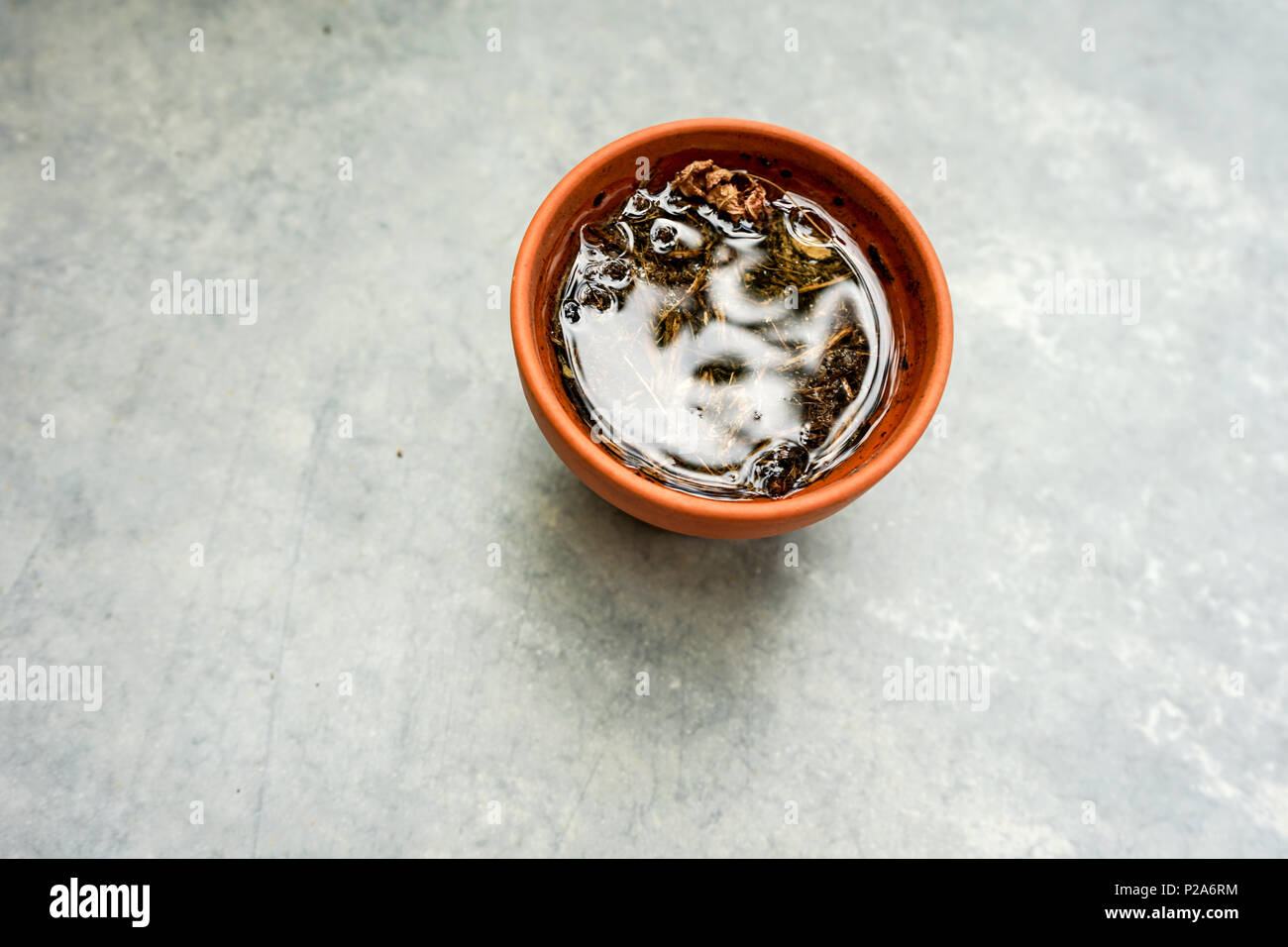 yellow watering can with dry ton pot giving water Stock Photo - Alamy