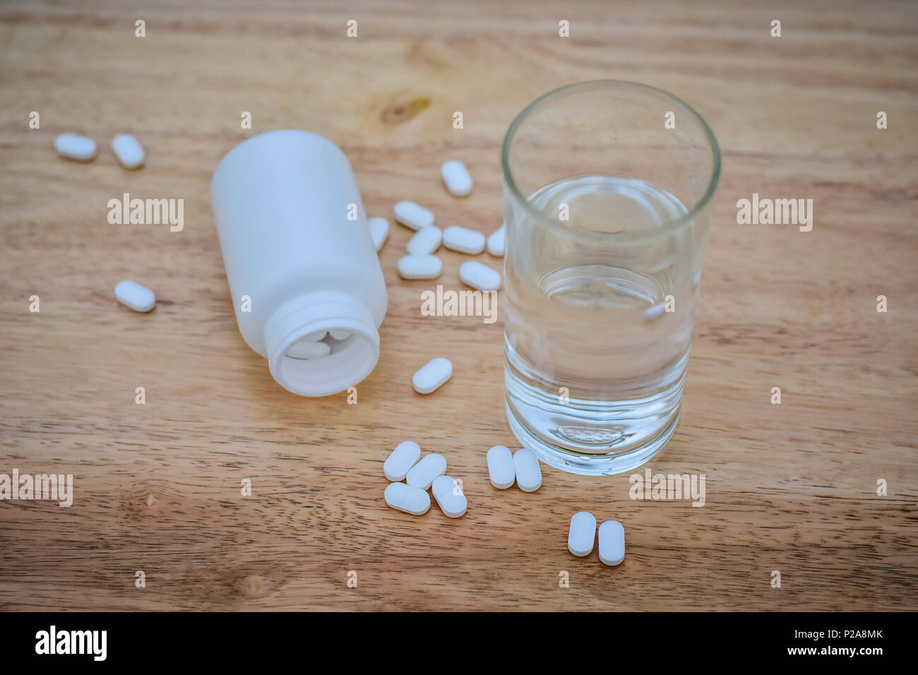 Paracetamol for reducing fever is placed on the table and a glass of ...