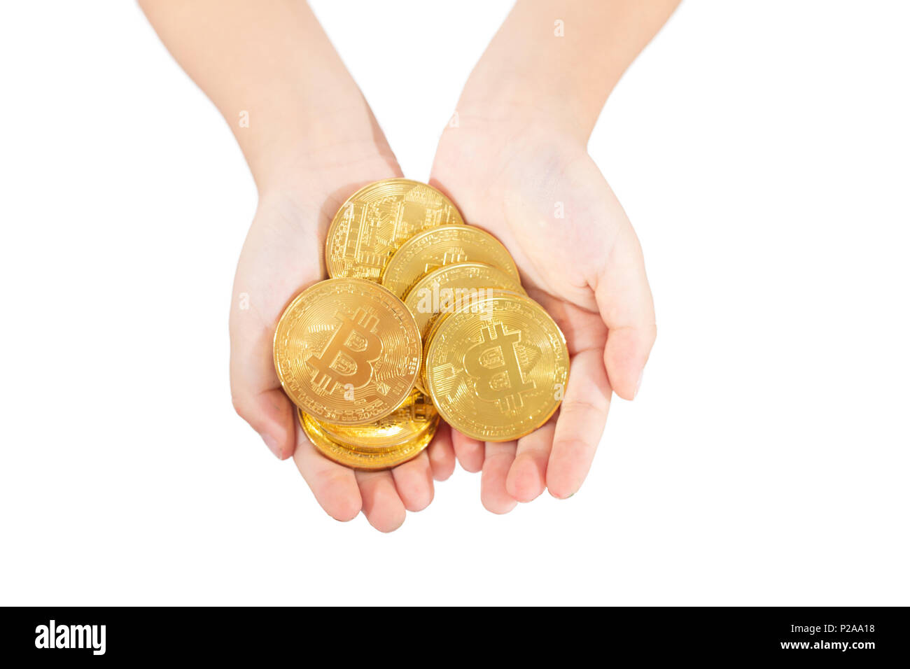 Children's hands holding golden Bitcoin in isolated white background ...