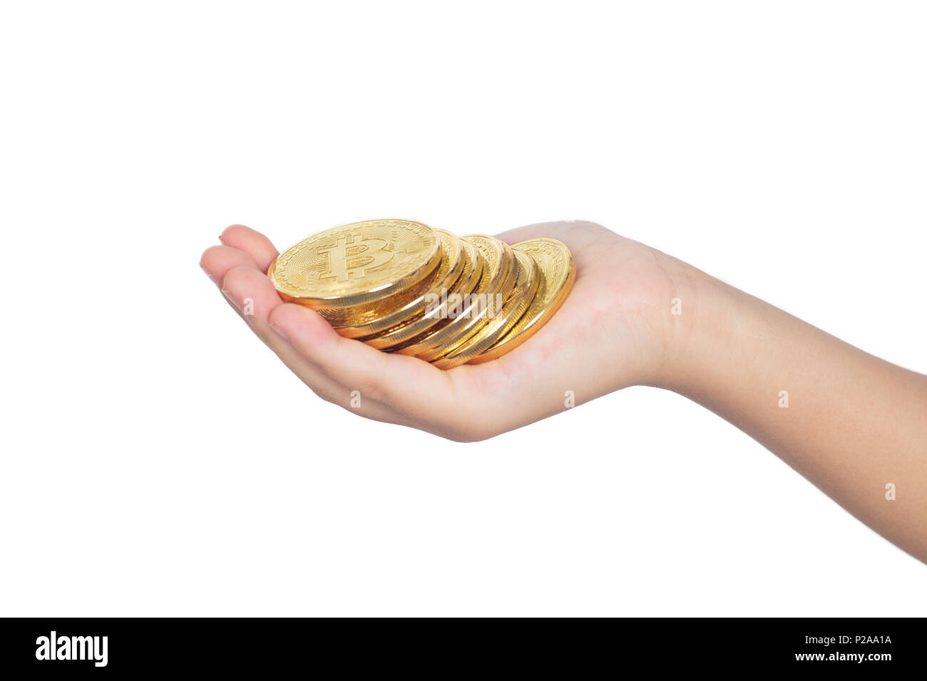 Children's hand holding golden Bitcoin in isolated white background ...