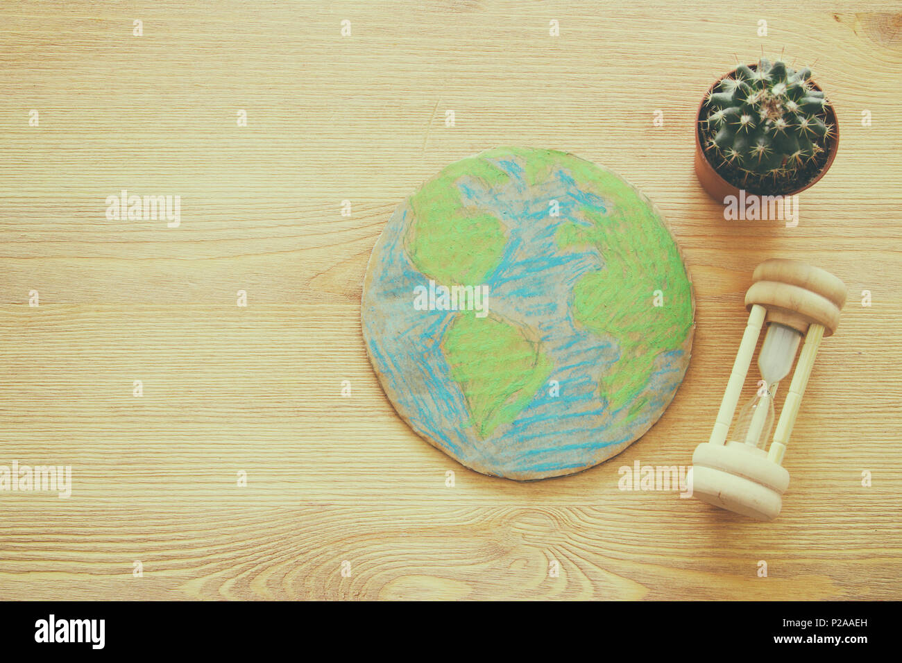top view image of desk with hourglass and earth globe Stock Photo - Alamy
