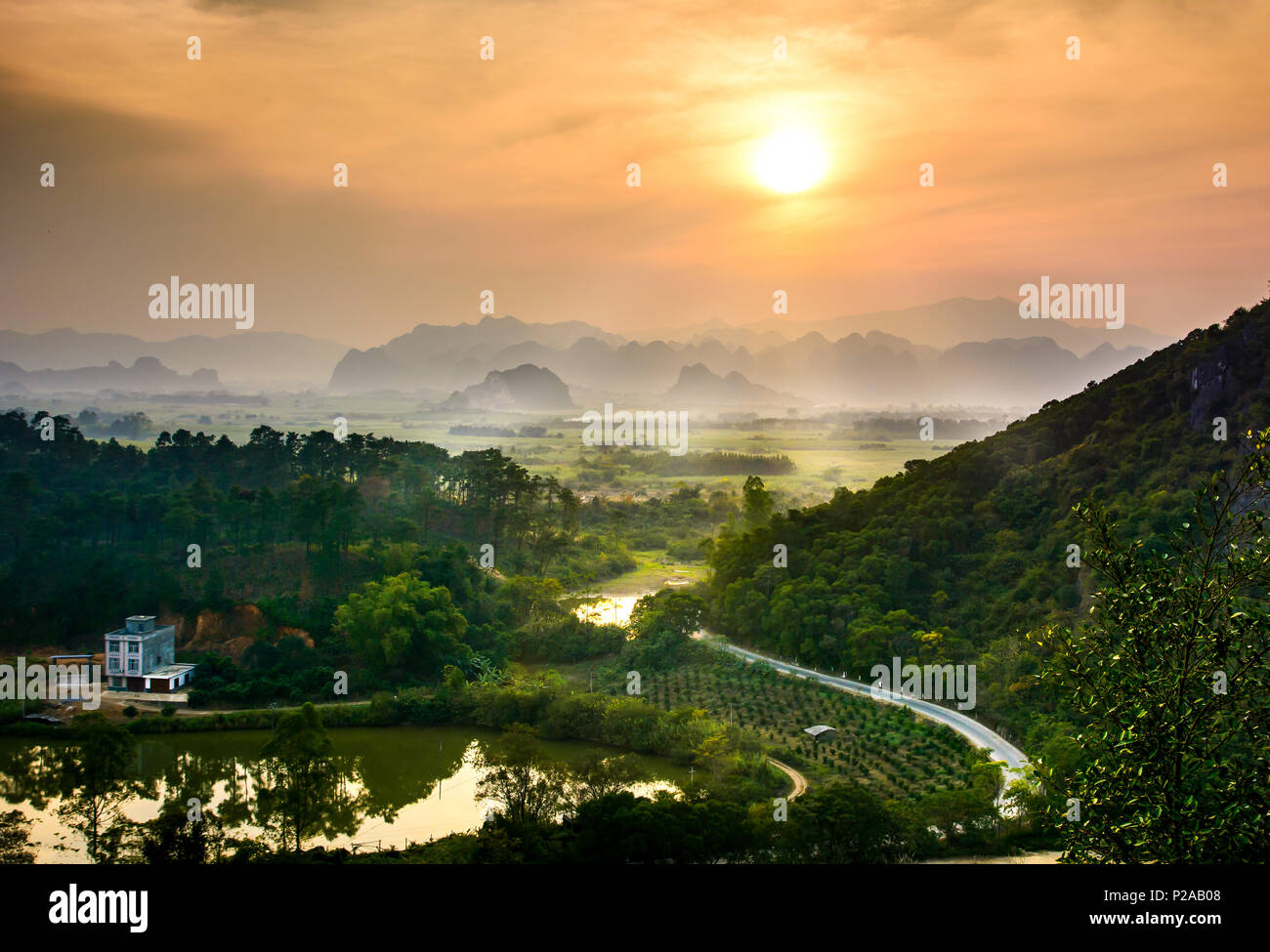 Idyllic sunset over Chinese rice fields and nature on Guangxi province ...